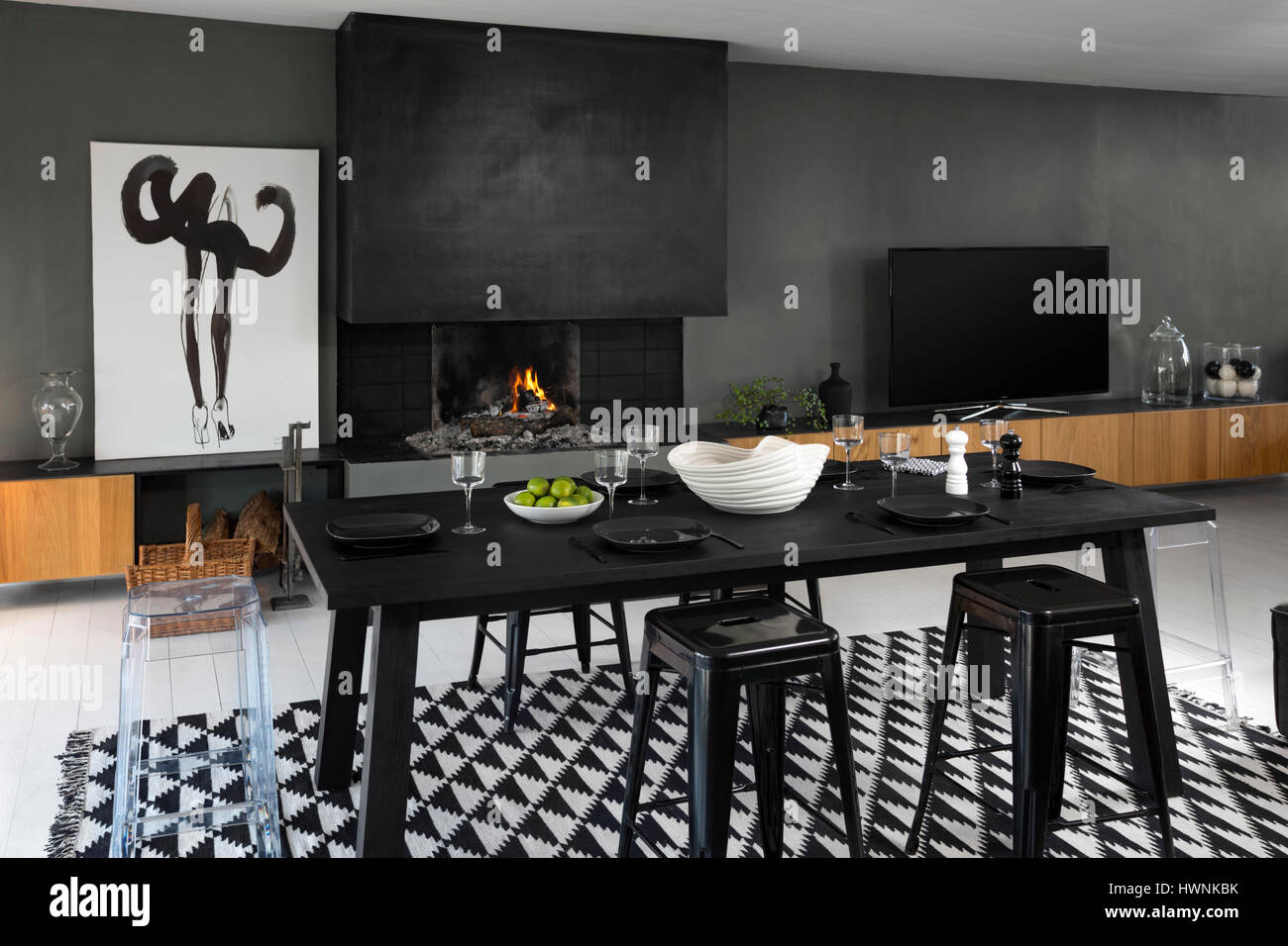 A laid out contemporary table - made out of a charred wood (shou-sugi ...