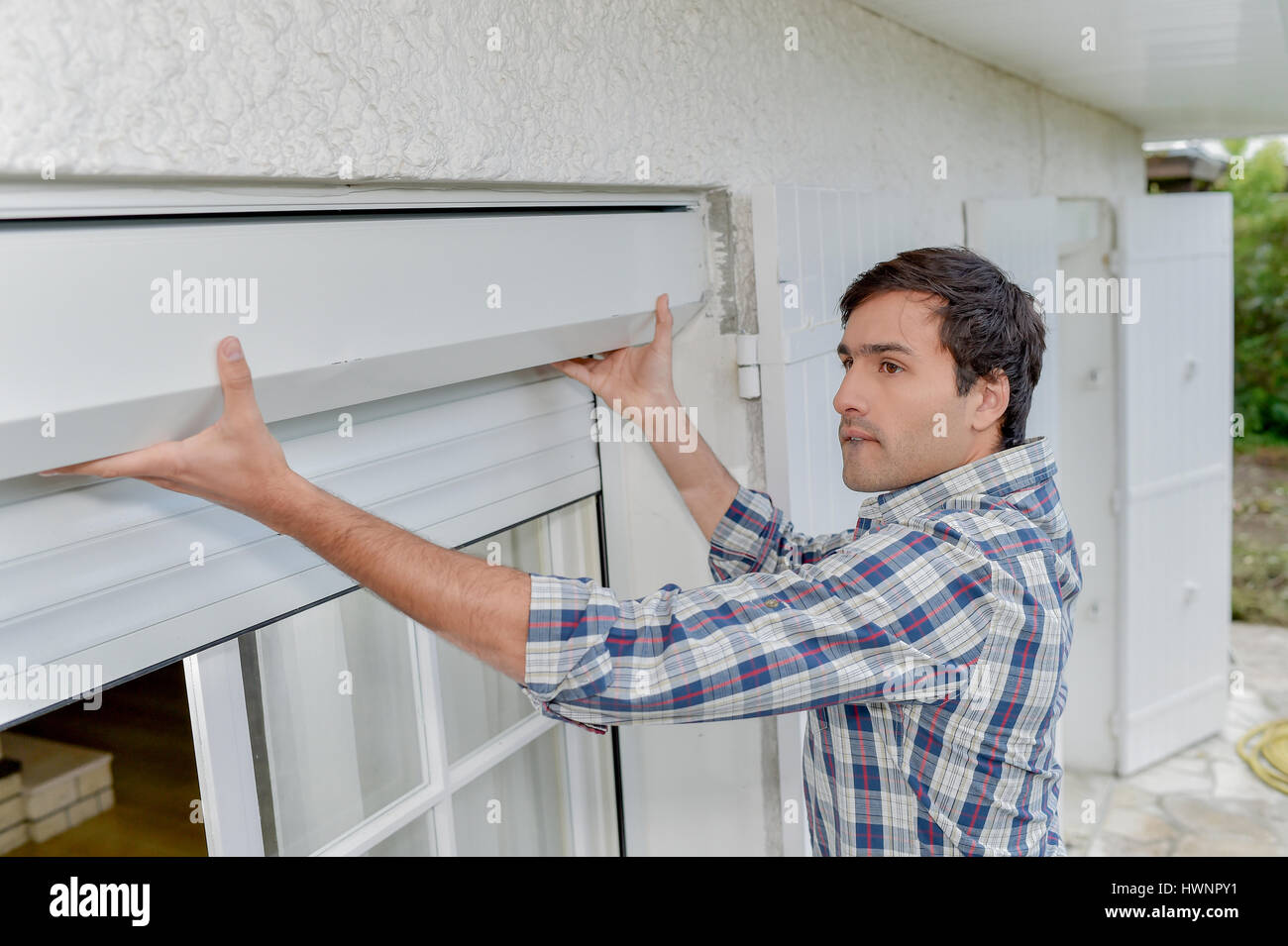 Fitting a new shutter system Stock Photo - Alamy