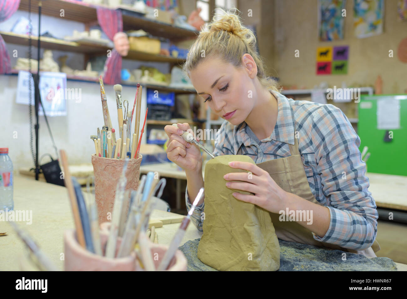 Artist working with clay Stock Photo - Alamy