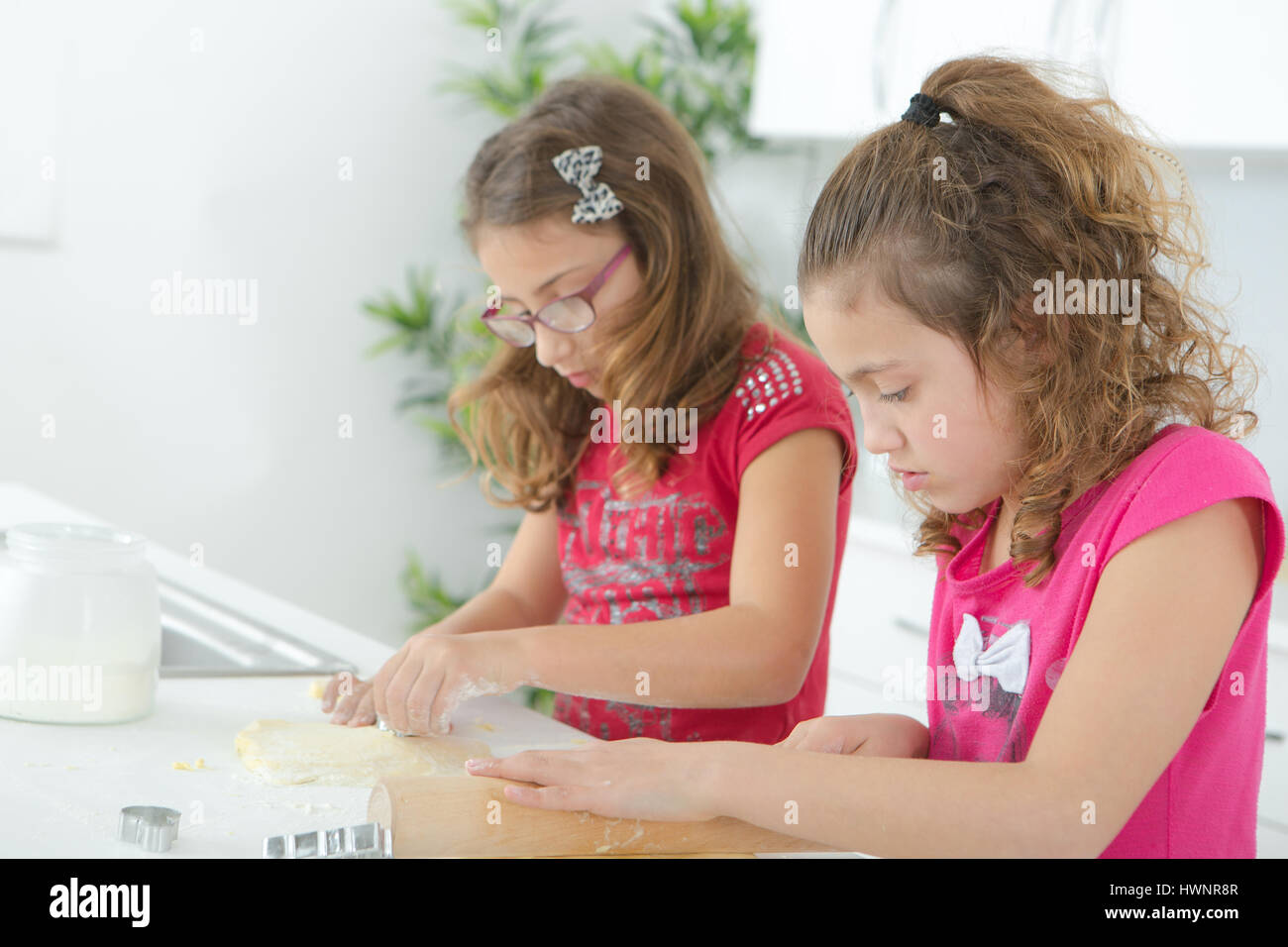 Two sisters baking together Stock Photo - Alamy