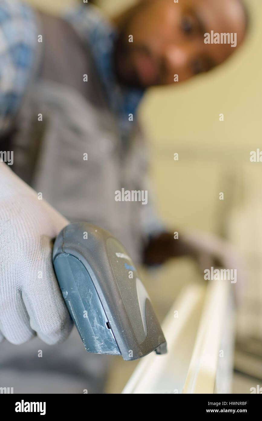 Closeup of man using handheld scanner Stock Photo - Alamy