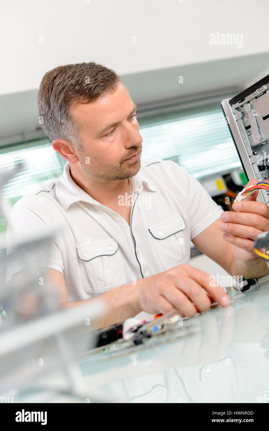 Man repairing his computer Stock Photo - Alamy