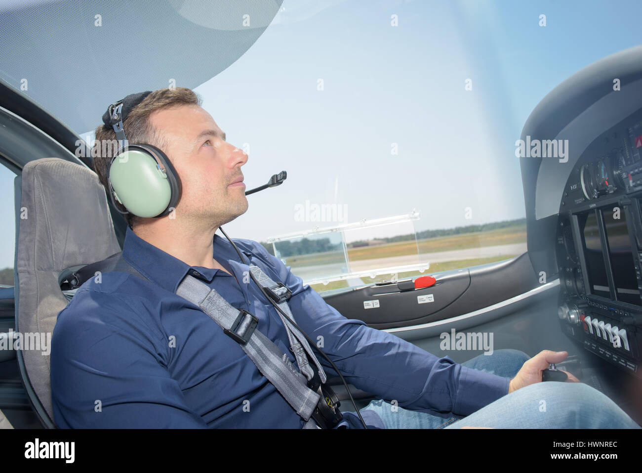 Man in cockpit of aircraft Stock Photo - Alamy