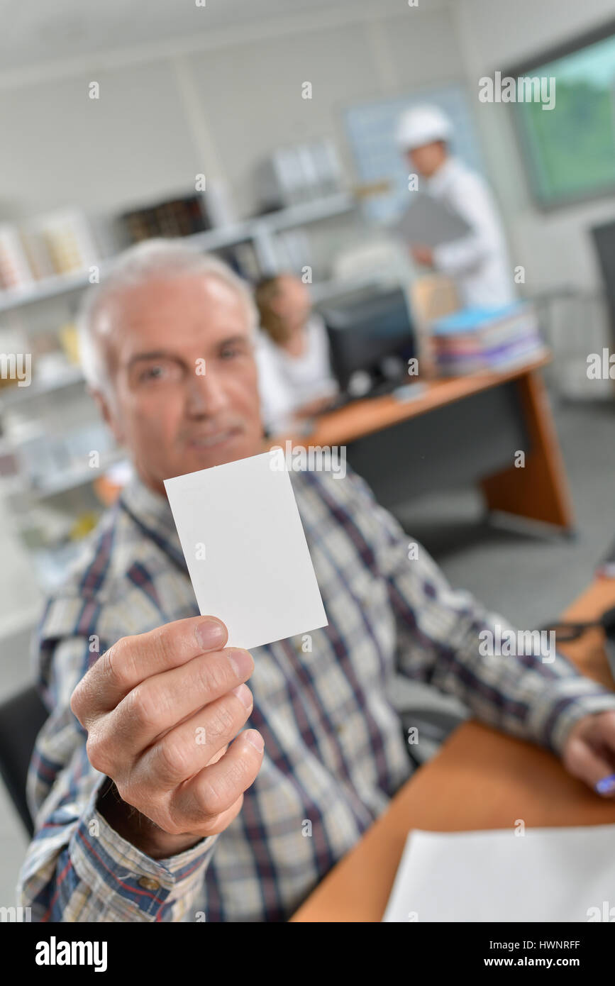 Manager holding out his visiting card Stock Photo - Alamy