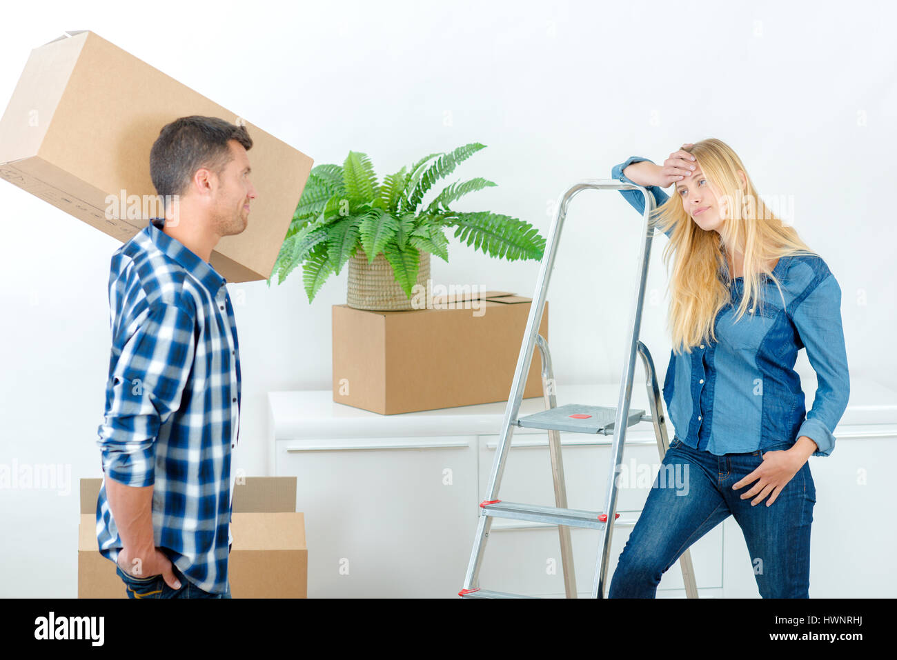 Couple feeling tired after moving house Stock Photo - Alamy