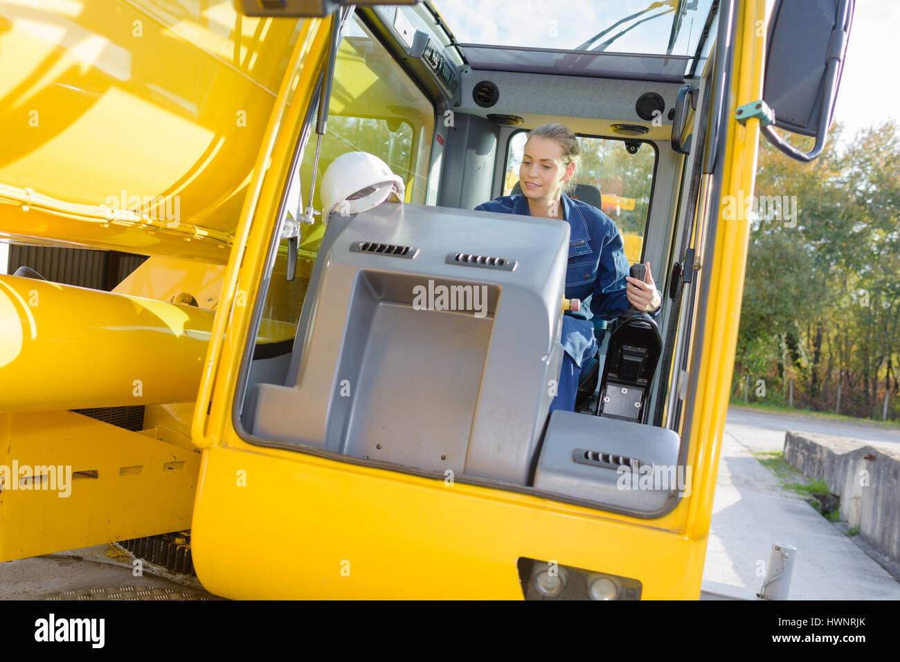 woman worker operating a vehicle Stock Photo - Alamy