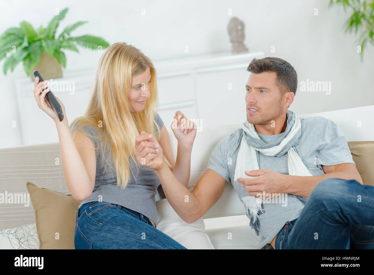 couple with remote control Stock Photo - Alamy