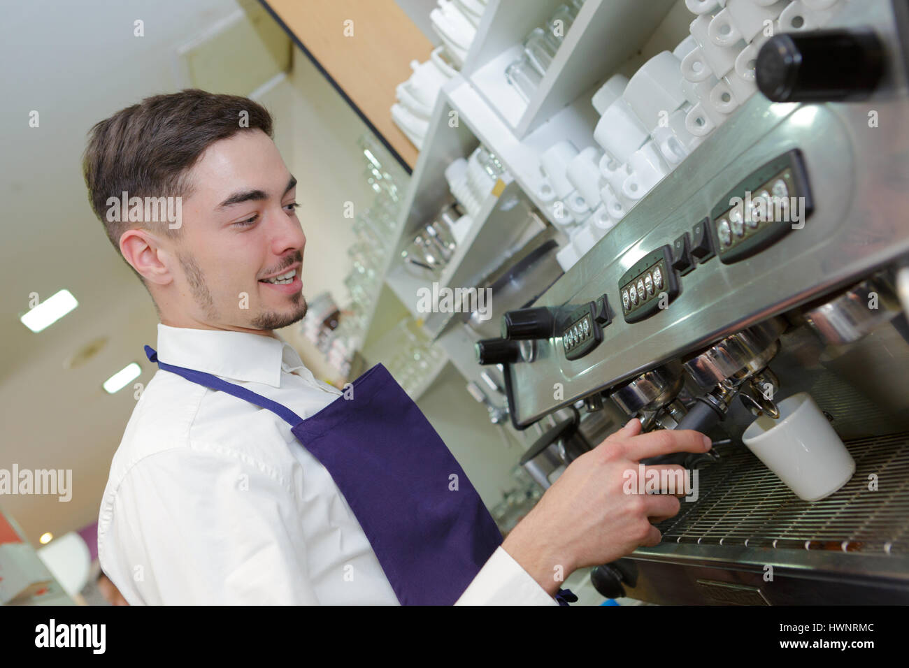 smiling waiter making cup of coffee at the coffee shop Stock Photo - Alamy