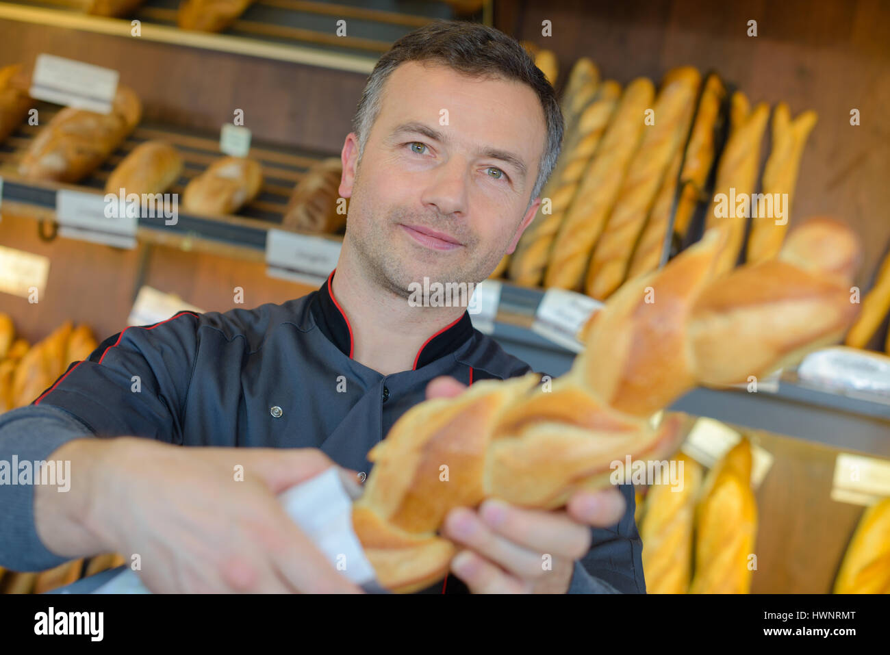 bakery shopkeeper is proud of his bread production Stock Photo - Alamy