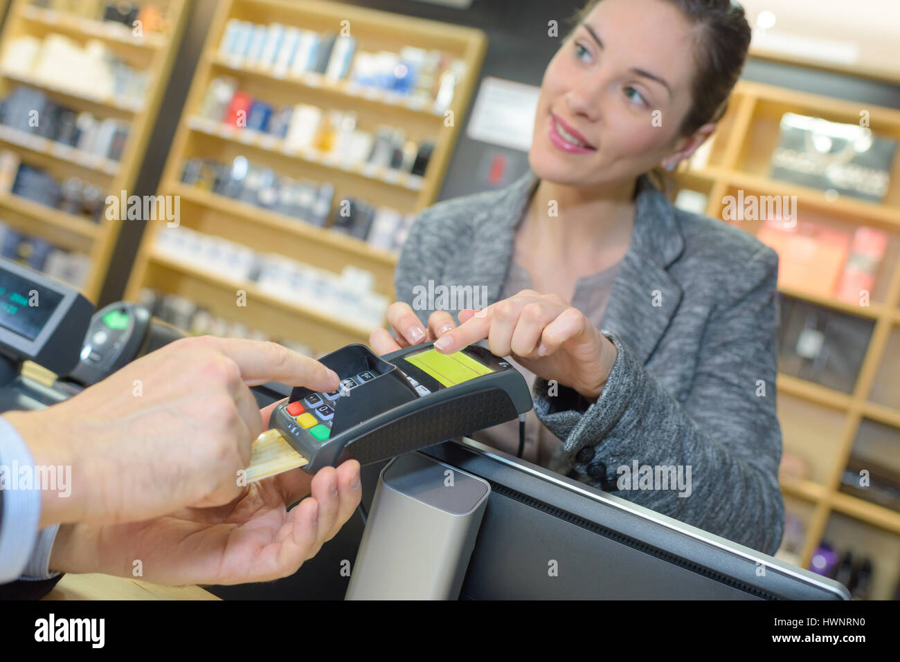 Woman taking payment from hi-res stock photography and images - Alamy