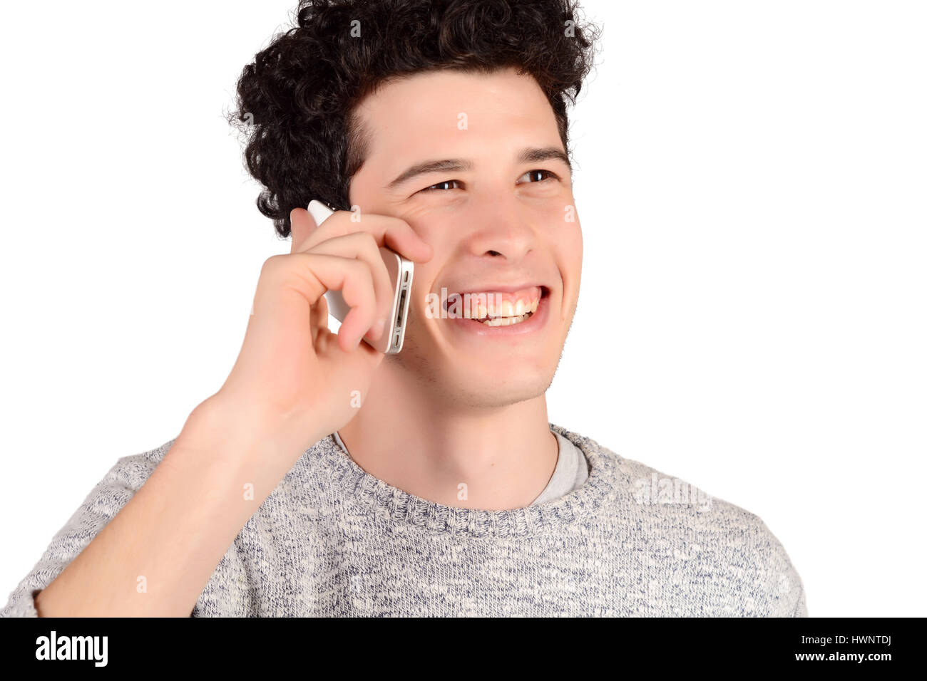 Portrait of a young handsome man talking on the phone. Isolated white ...