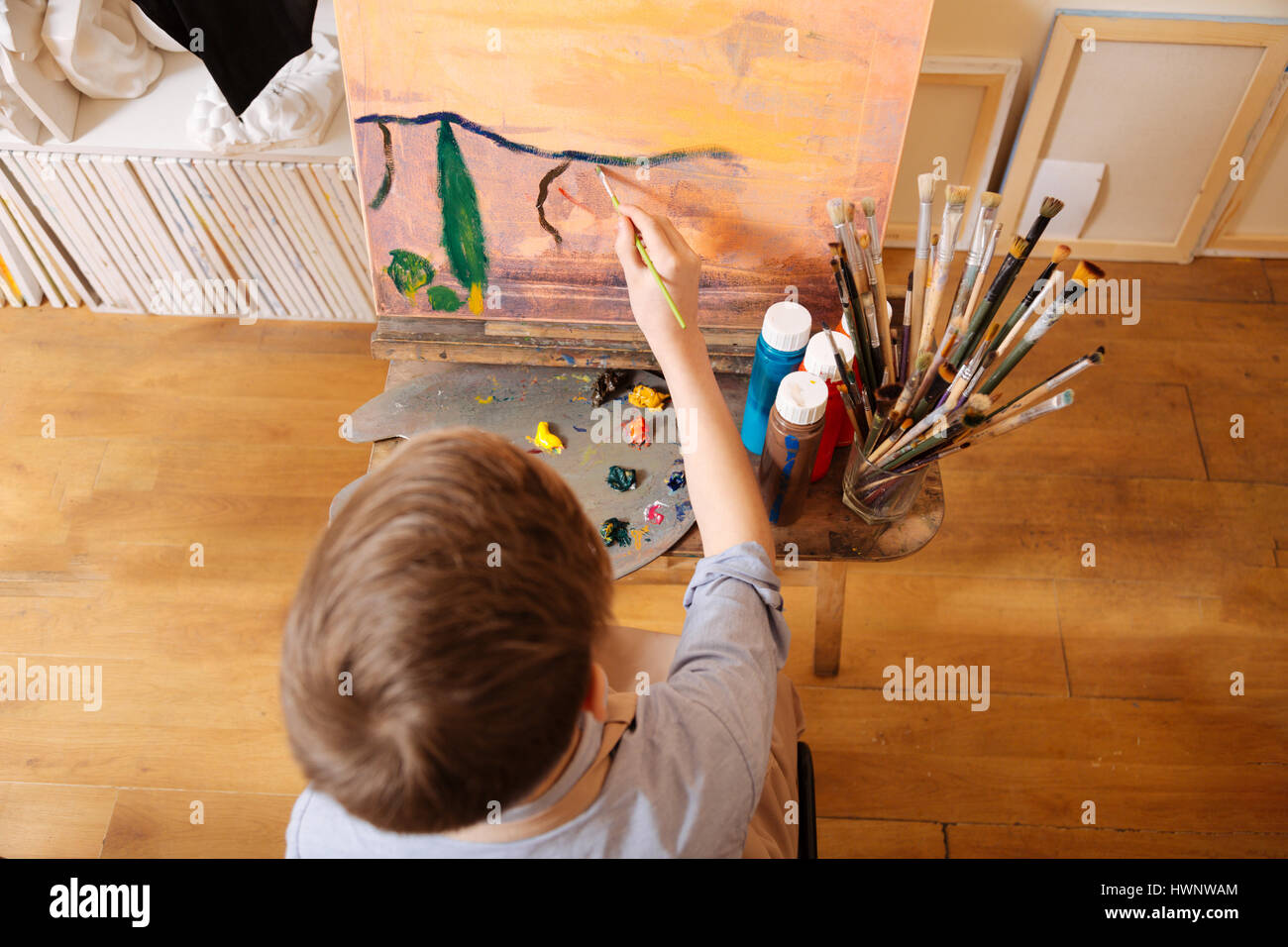 Painting the landscape. Young capable skilled boy sitting in the art ...