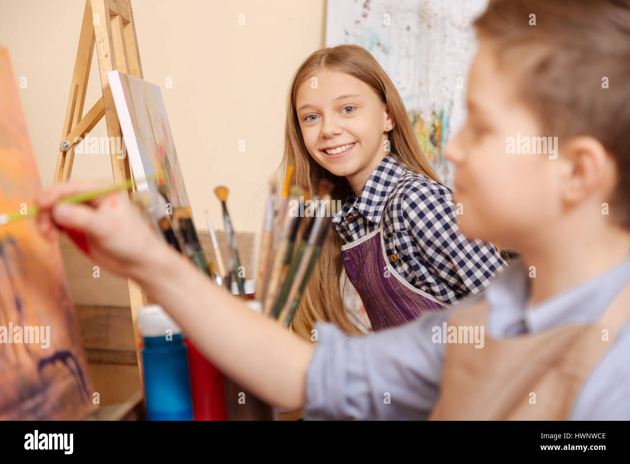 Full of joy. Cheerful delighted smiling children sitting in the school ...