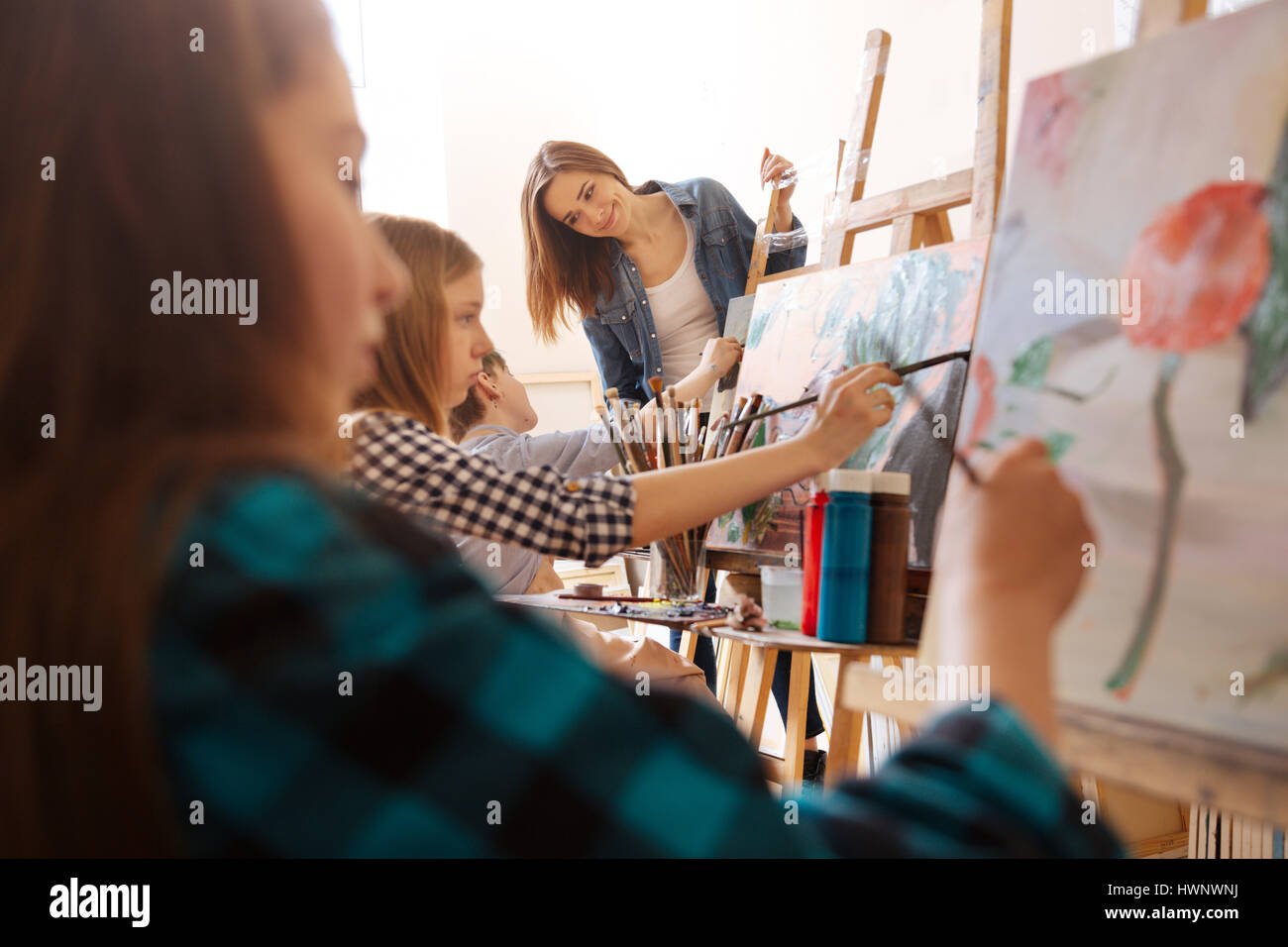 With positivity in every motion . Smiling optimistic charming teacher ...