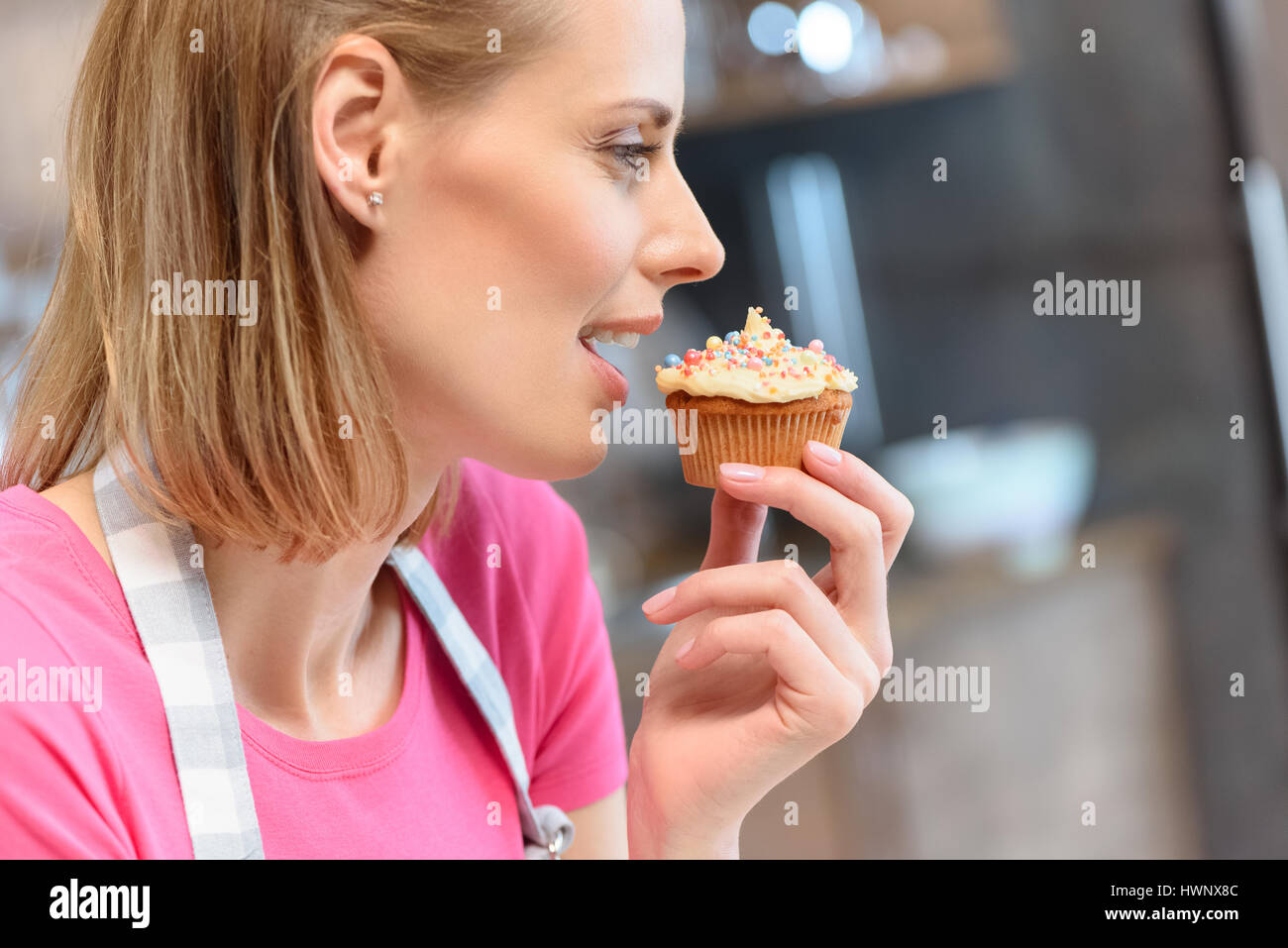 Happy girl eating cupcake hi-res stock photography and images - Alamy