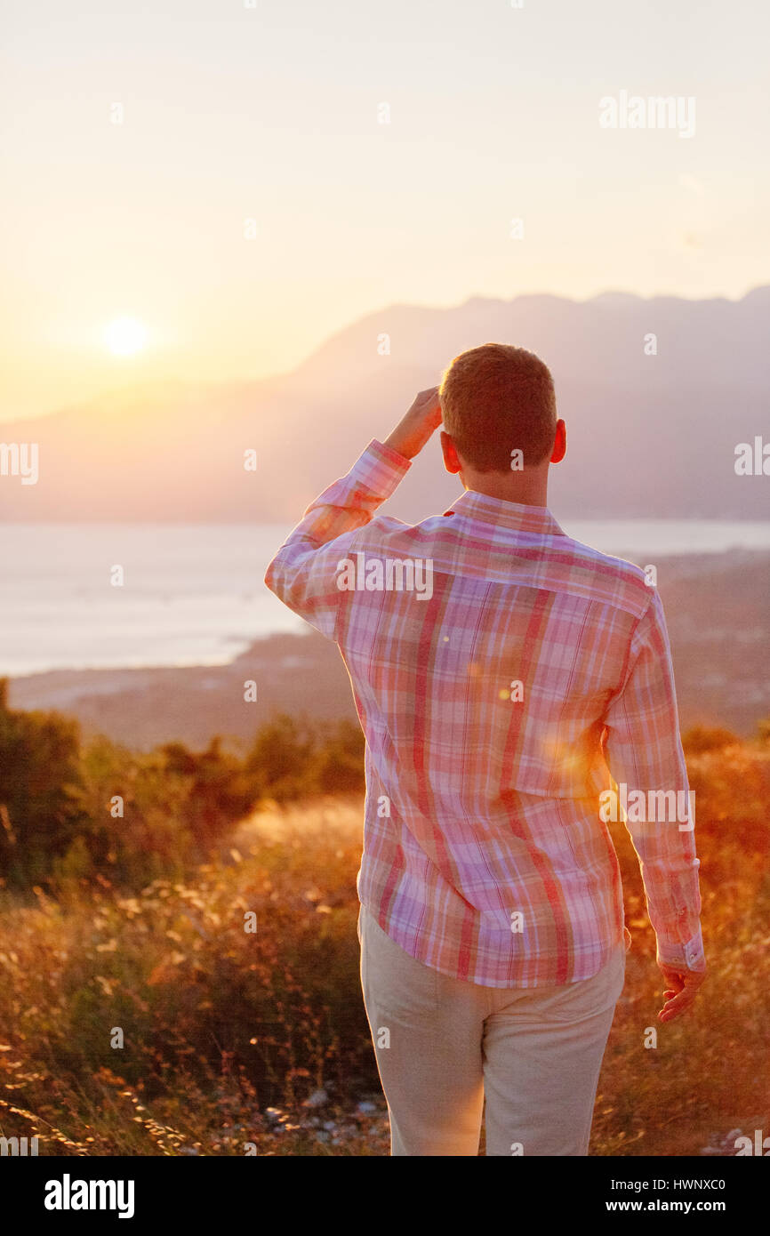 man look over horizon. Sunset in mountains Stock Photo - Alamy