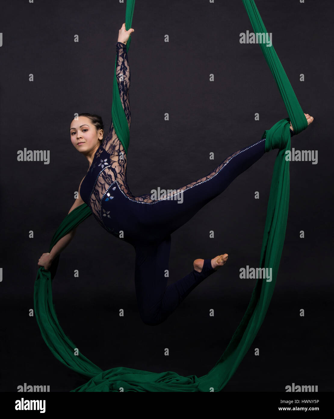woman's aerial acrobatics in the paintings - dark background. Studio ...