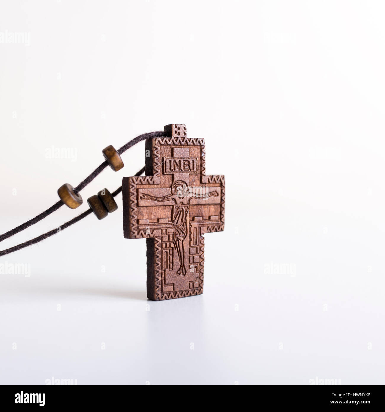 Wooden cross on white table top, close up Stock Photo - Alamy