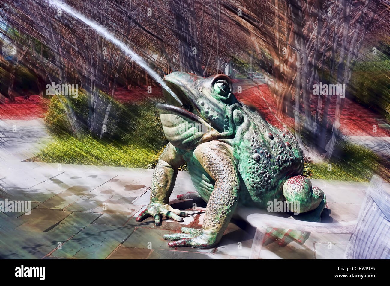 Surreal spitting green frog in park Stock Photo - Alamy