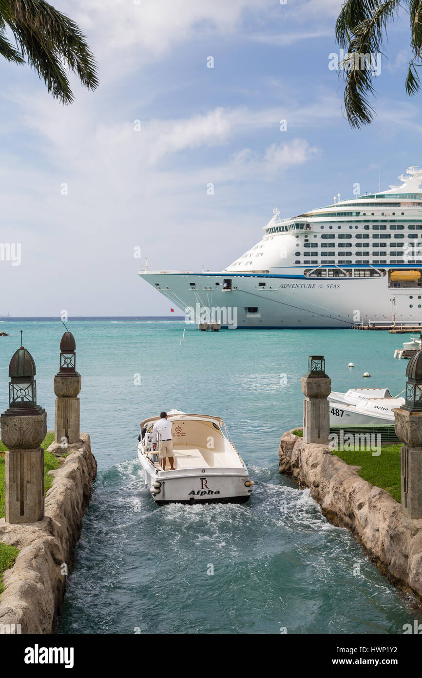 Inlet for small boats into a bay with luxury cruise ship anchored Stock ...