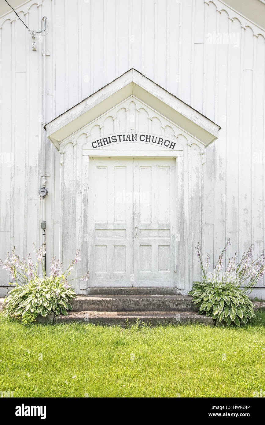 Christian Church sign above the doors to a white painted church in ...