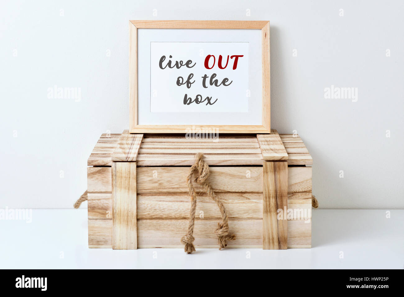 a wooden-framed picture with the text live out of the box written in it ...