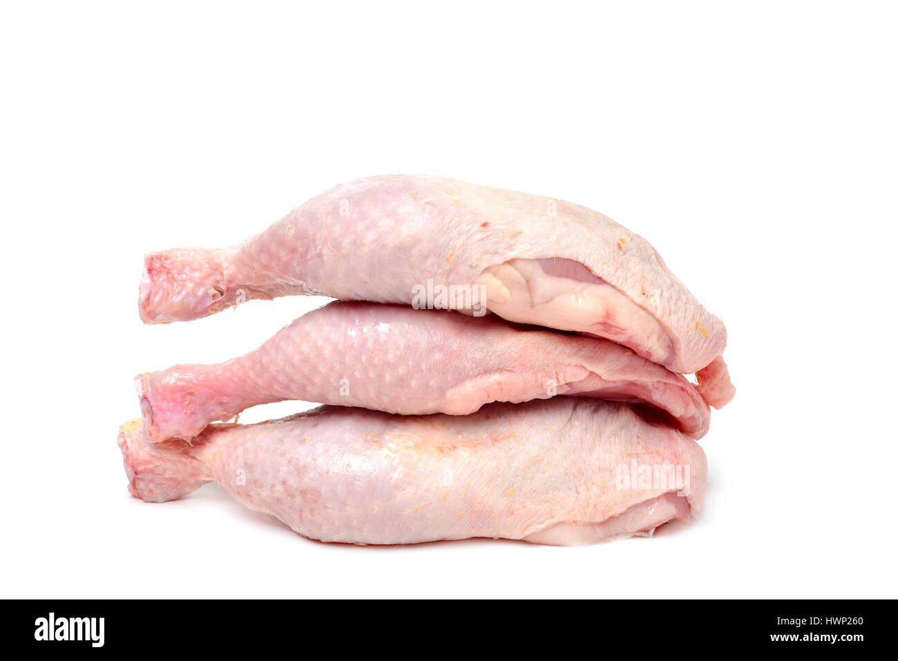 closeup of some raw chicken legs on a white background Stock Photo - Alamy