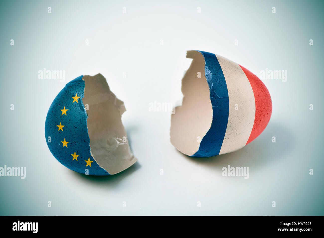 the two halves of a cracked eggshell, one patterned with the flag of ...