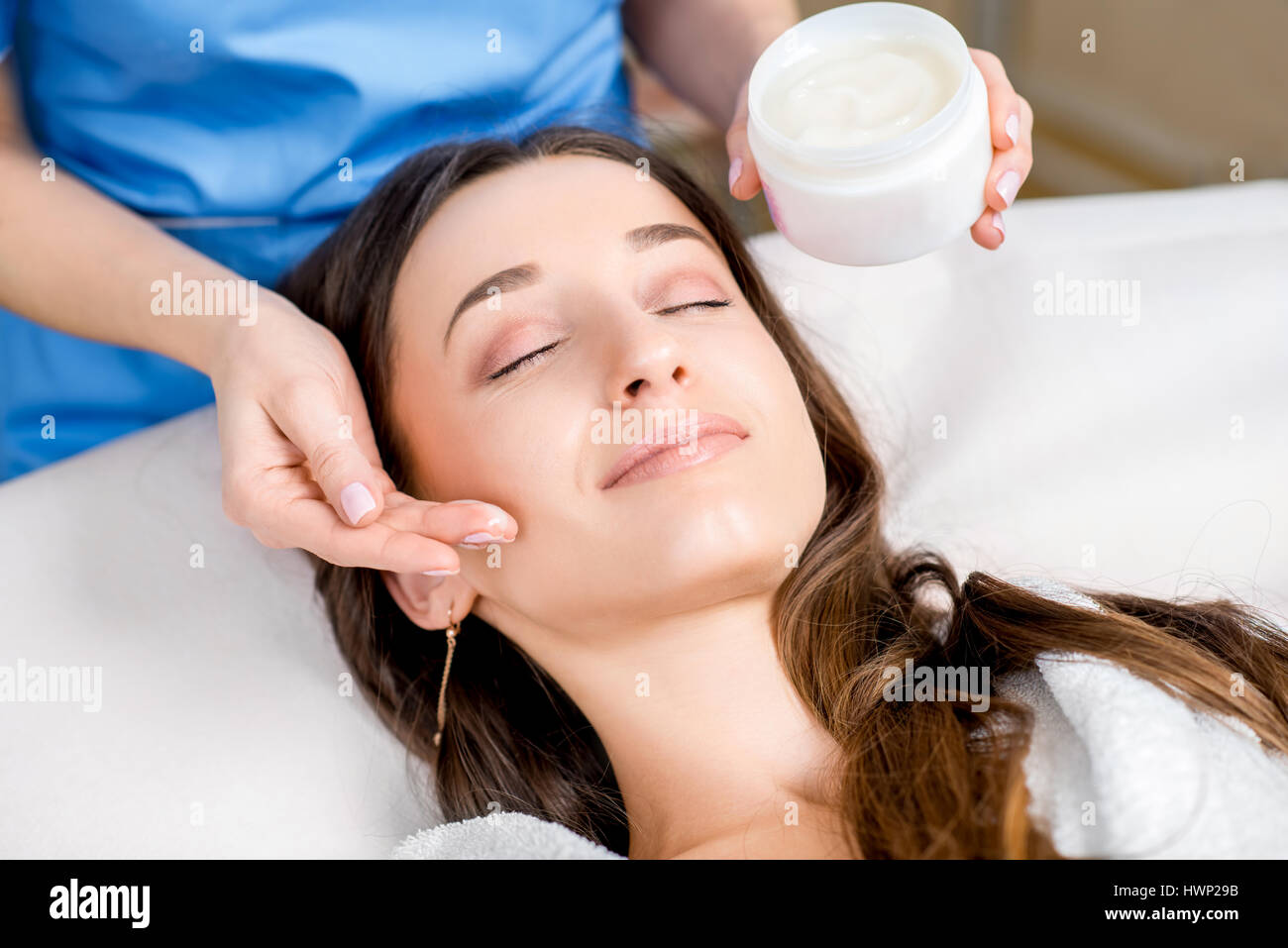 Applying facial cream Stock Photo - Alamy