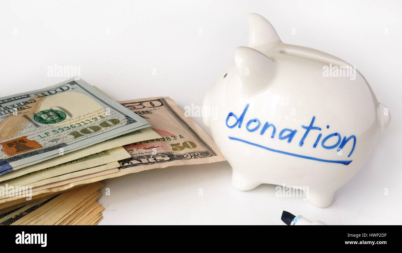 Word donation written on a side of piggy bank Stock Photo - Alamy