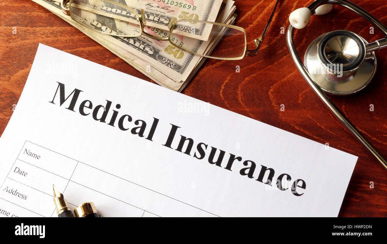 Medical insurance policy on a table Stock Photo - Alamy