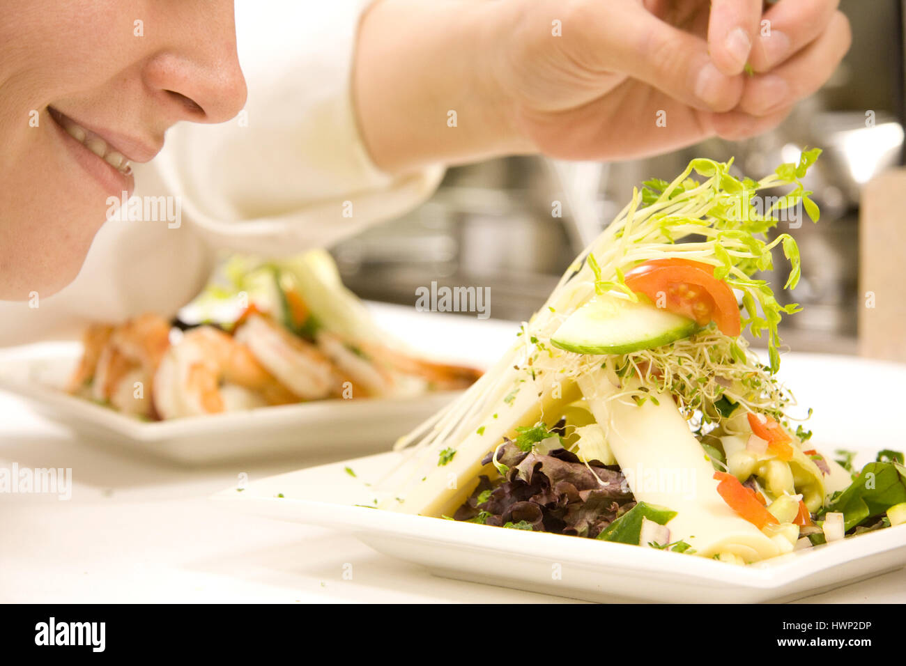 Happy smiling chef garnish a salad Stock Photo - Alamy