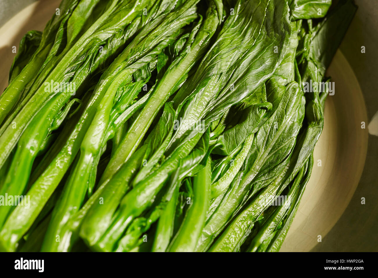 A plate of cooked Chinese Broccoli Stock Photo - Alamy