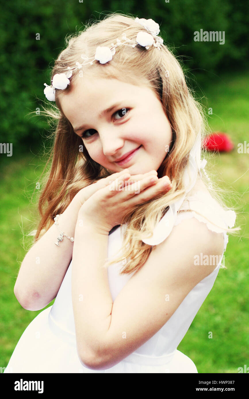 Girl on her first holy communion day in the garden Stock Photo - Alamy