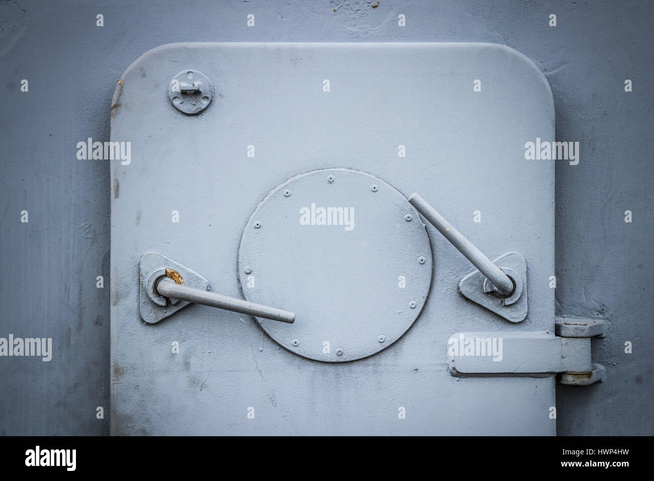 Grey closed ship door with two levers Stock Photo - Alamy