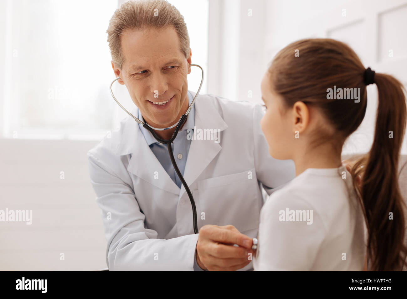 I will listen. Lovely delighted qualified doctor telling girl breathing ...