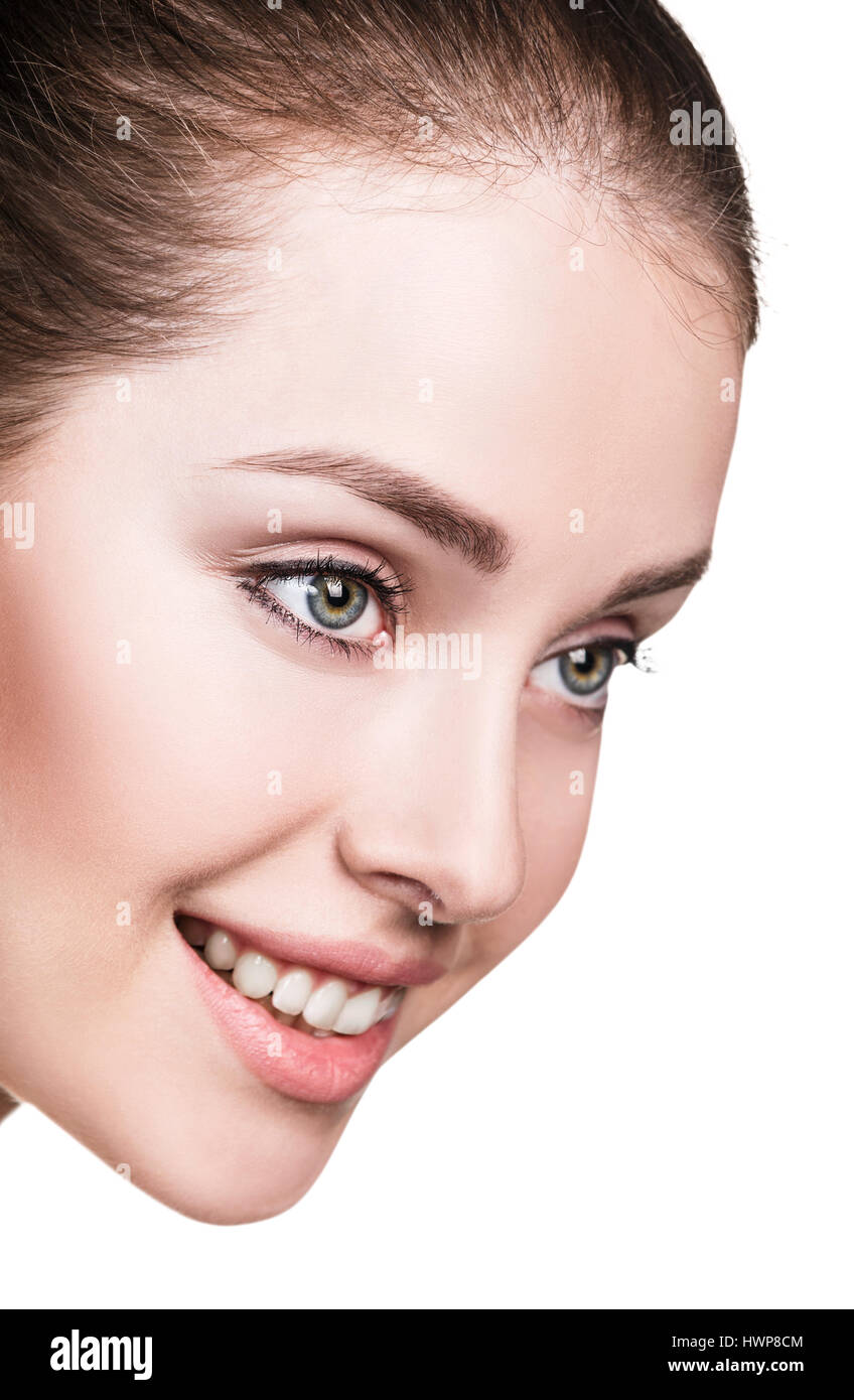 Beautiful young woman's face with clean skin over white background ...