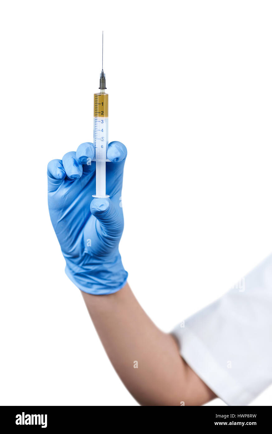 Hand with syringe close-up over blue background Stock Photo - Alamy