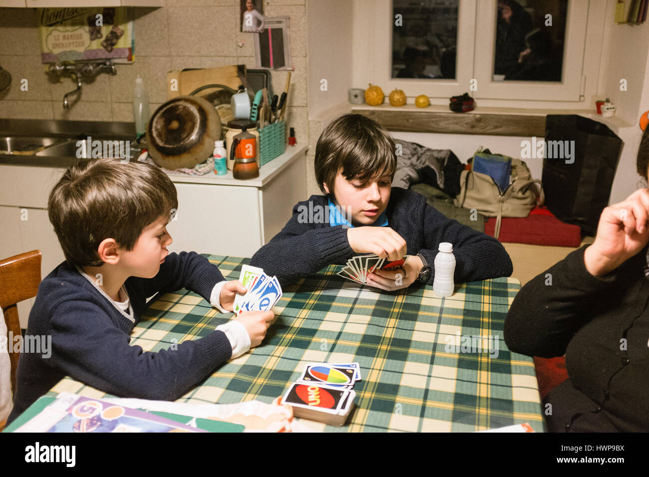 Children play cards at home at the kitchen table Stock Photo - Alamy