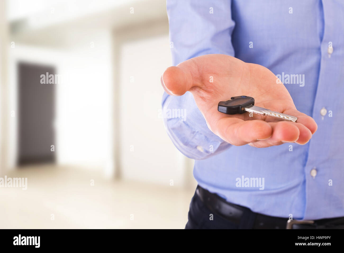 Business man holding a key Stock Photo - Alamy