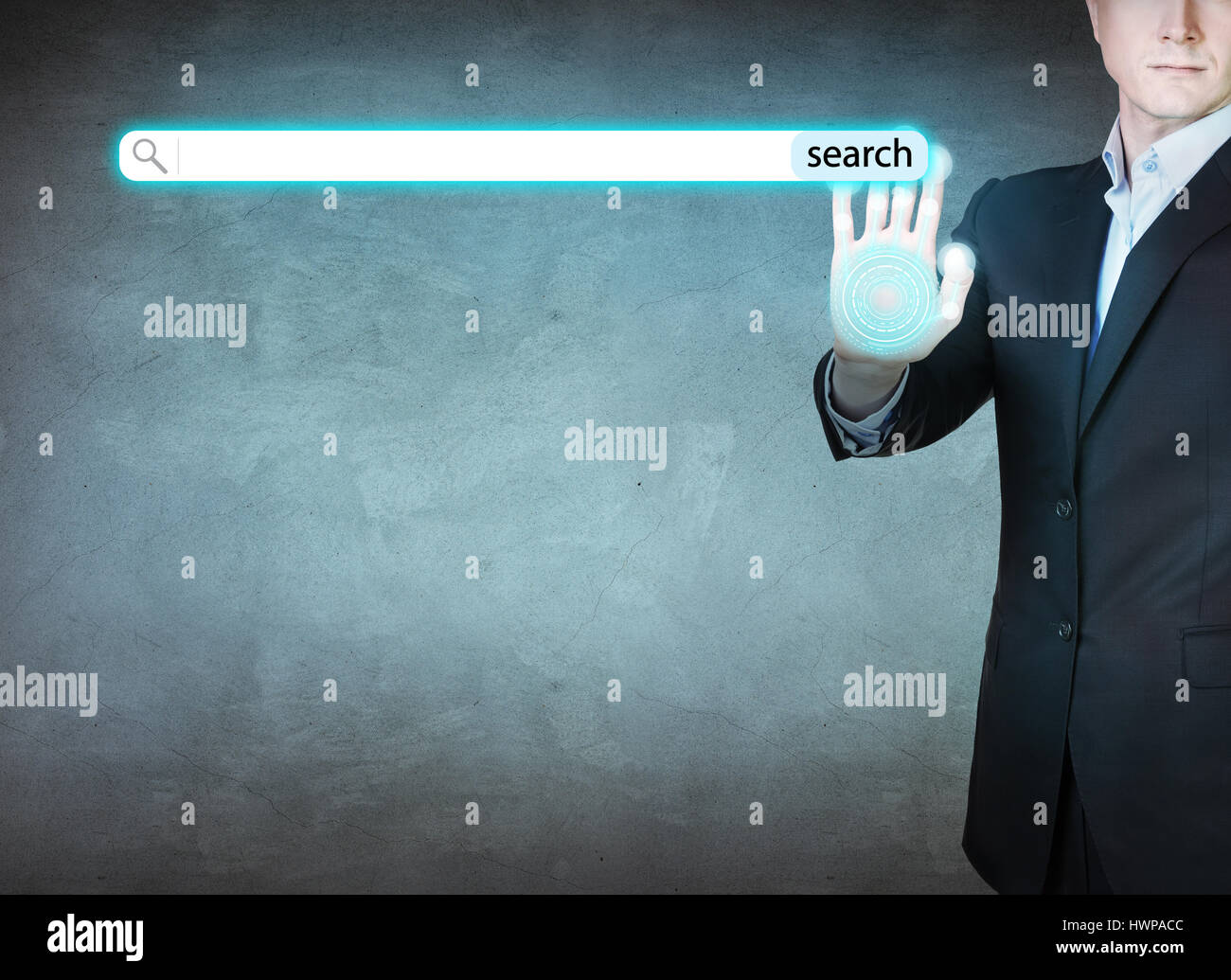 Businessman pushing digital searching button over dark wall background ...