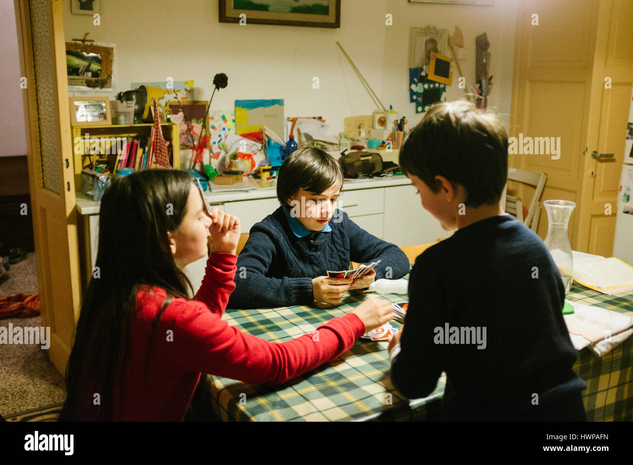 Children play cards at home at the kitchen table Stock Photo - Alamy