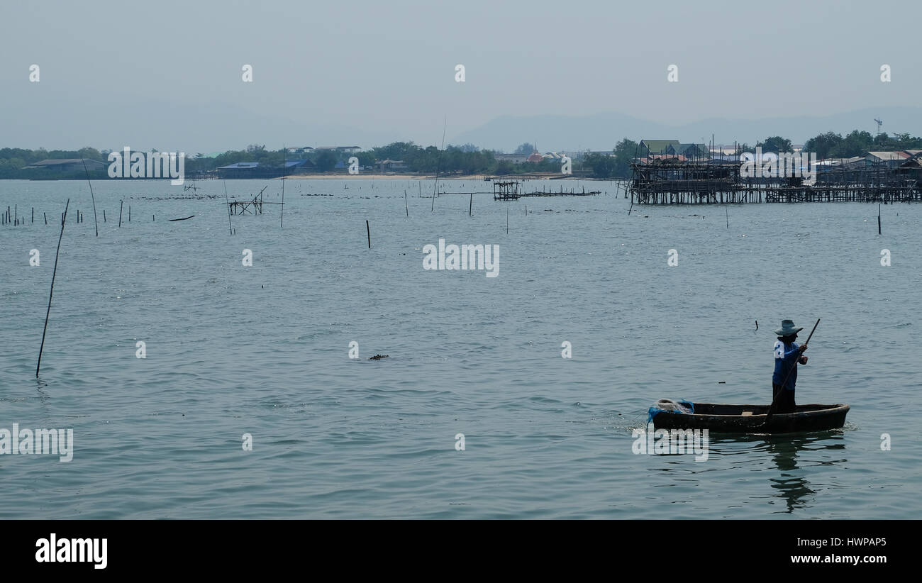 A fisherman rowing a boat Stock Photo - Alamy