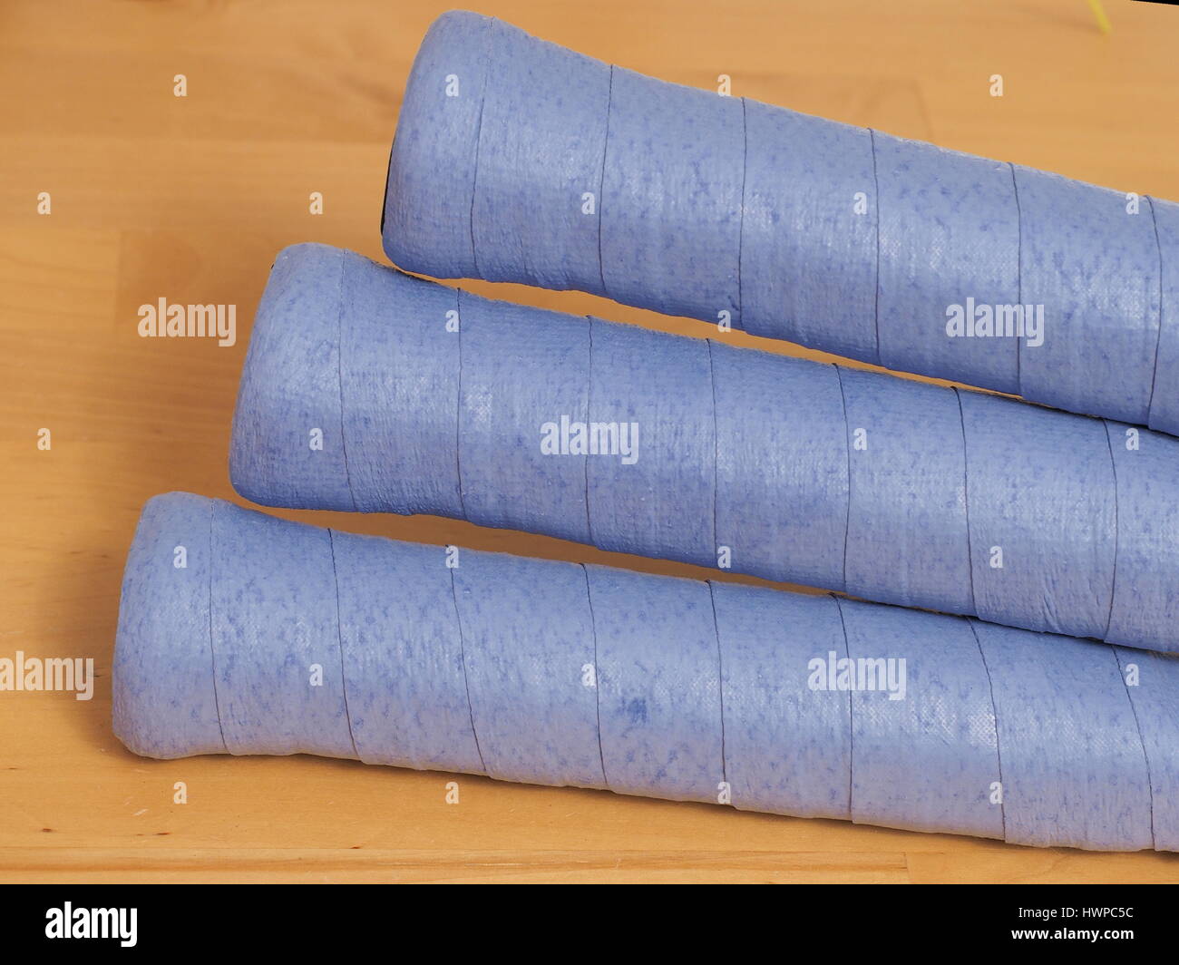 Freshly wrapped blue over grips on 3 Tennis rackets providing a tacky ...