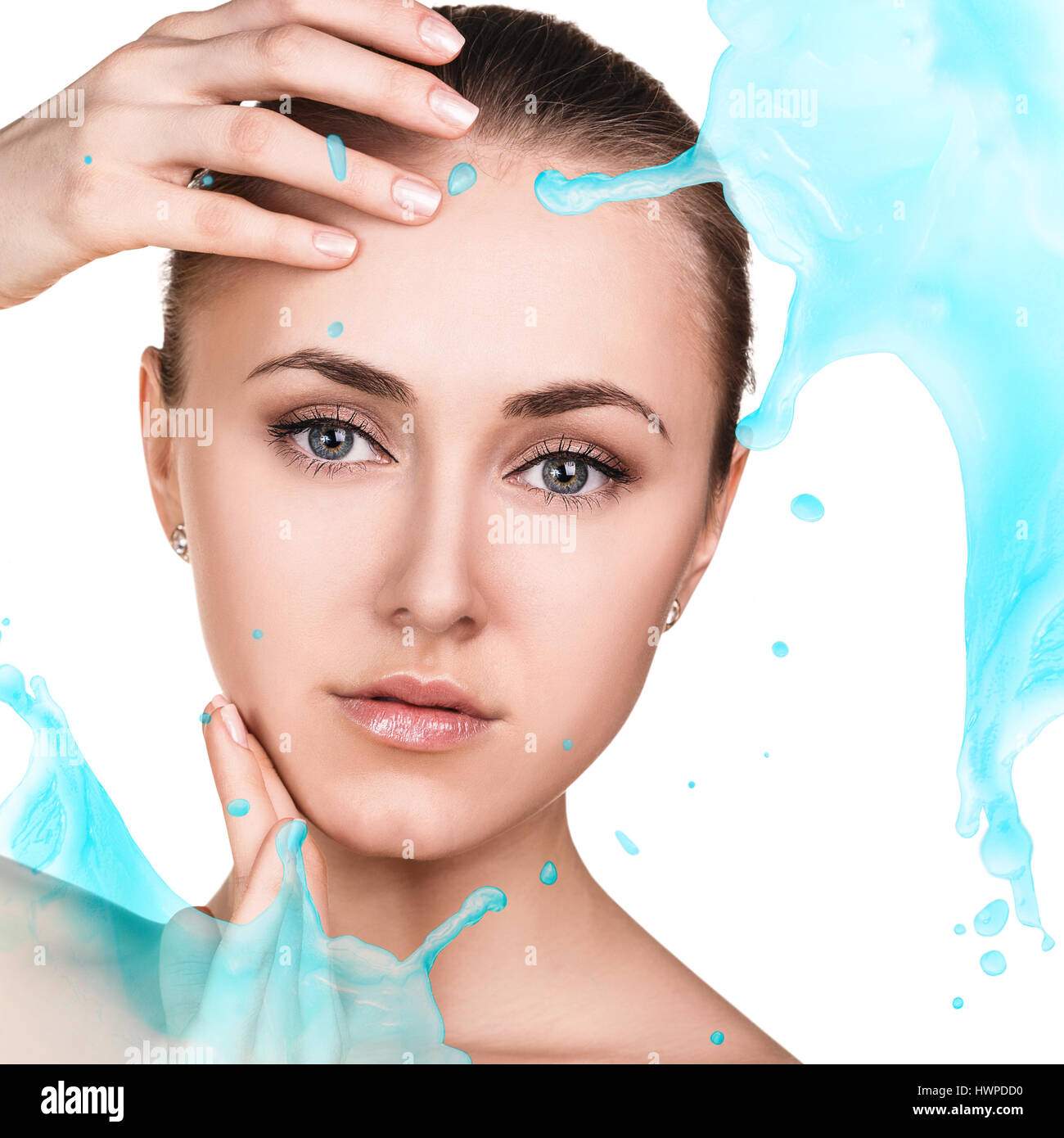 Young woman face in splashes of water over white background. Moistening ...