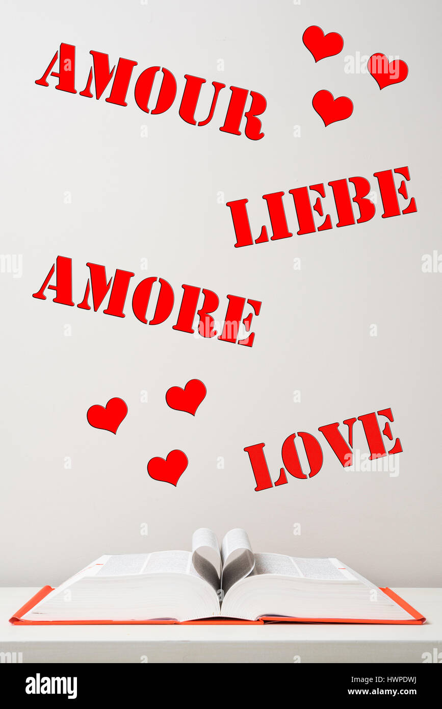 Heart shaped sheets with words of love from an opened book Stock Photo ...