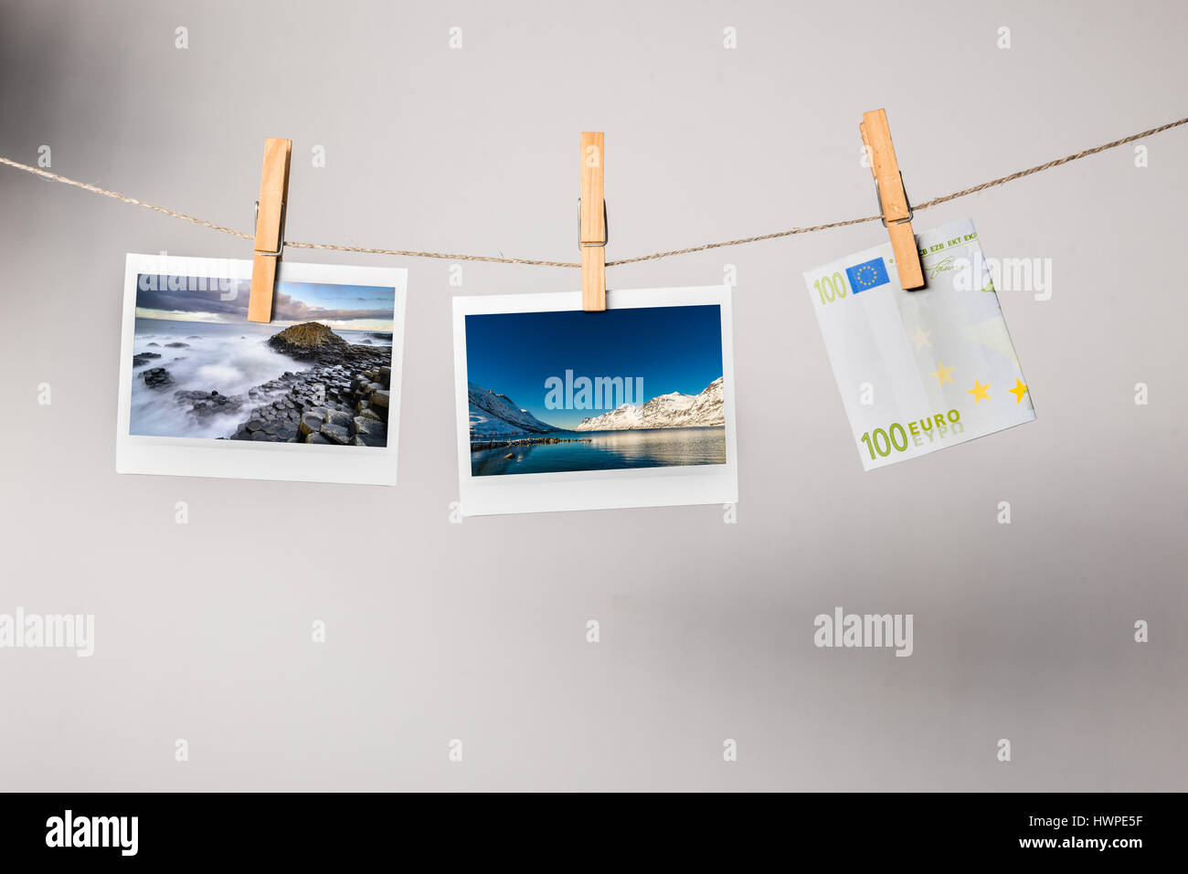 Two photograph and one bank note hungning on the string Stock Photo - Alamy