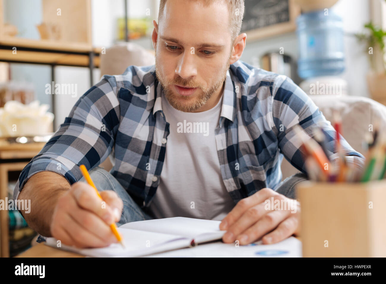 Handsome creative man taking notes Stock Photo - Alamy