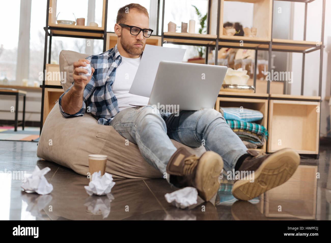 Hard working creative man holding crumpled ball of paper Stock Photo ...
