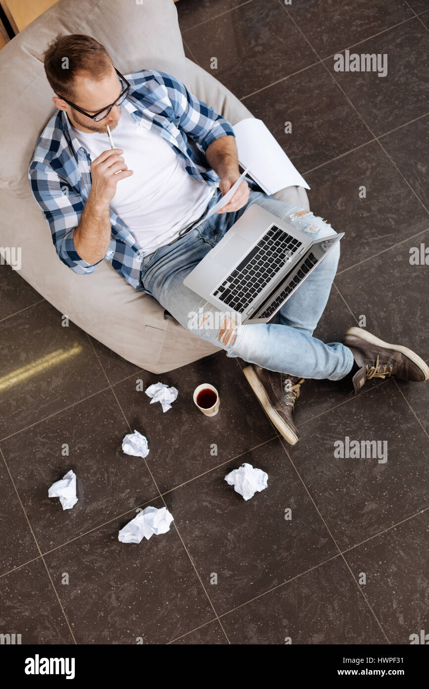 Top view of a nice thoughtful man biting his pen Stock Photo - Alamy